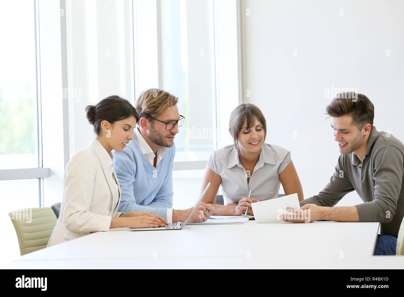 Business people meeting around table in modern space Stock Photo - Alamy