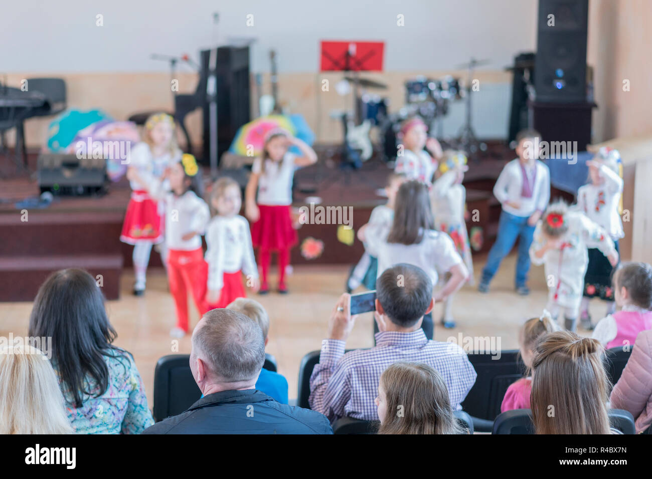 Children's holiday in kindergarten. Children on stage perform in front ...