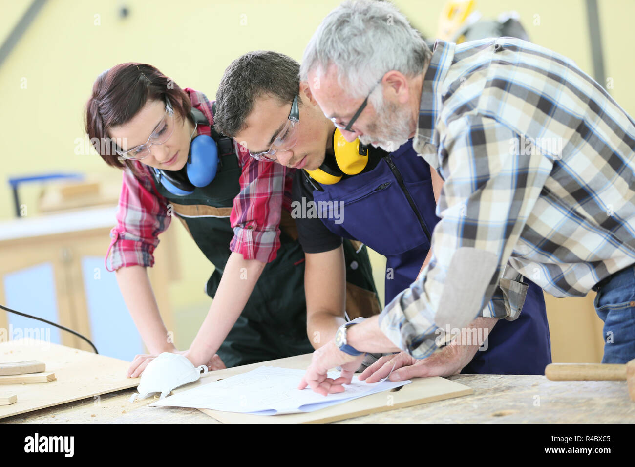 Young people in carpentry course with teacher Stock Photo - Alamy
