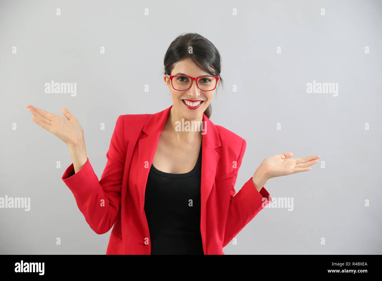 Beautiful brunette girl with red jacket pointing at message Stock Photo ...
