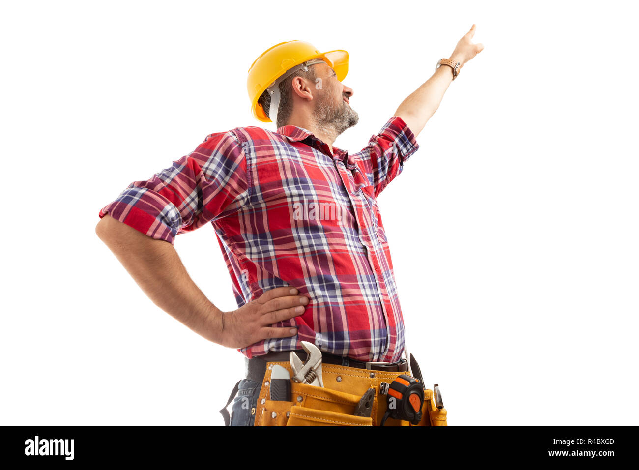 Below shot of male builder pointing upwards with index finger isolated ...