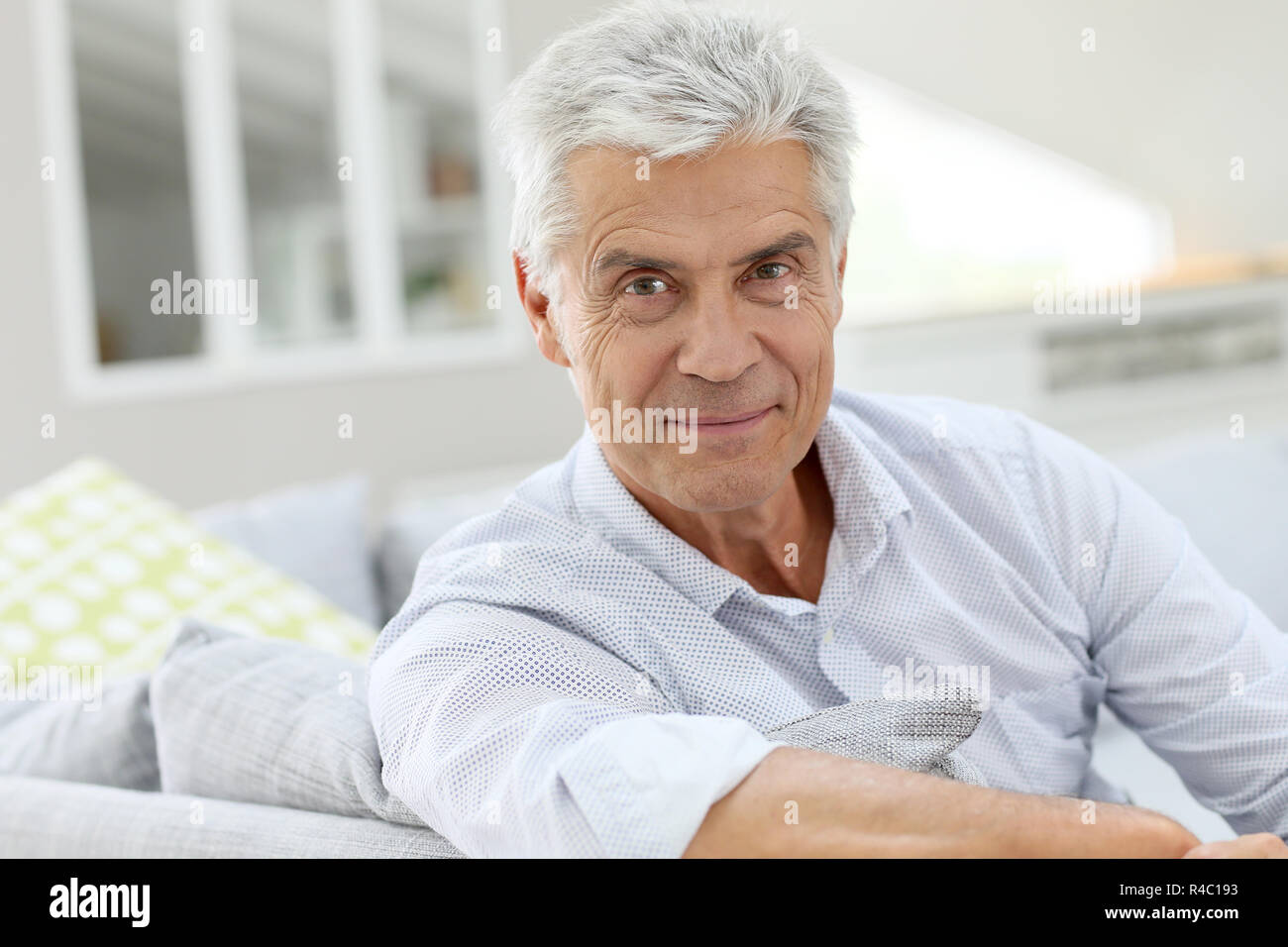 Portrait of elderly man relaxing in sofa at home Stock Photo - Alamy