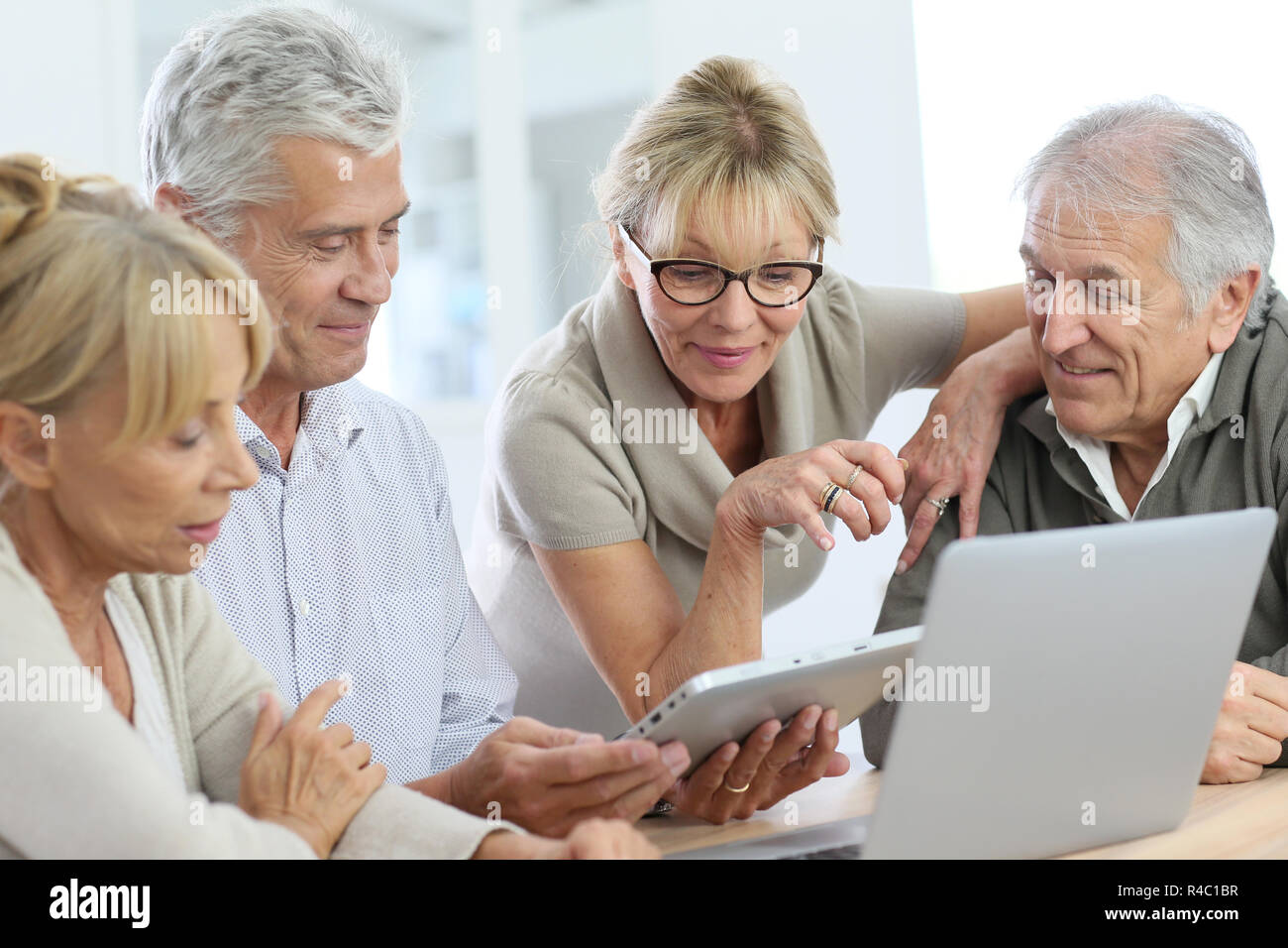 Group of retired senior people using laptop and tablet Stock Photo - Alamy