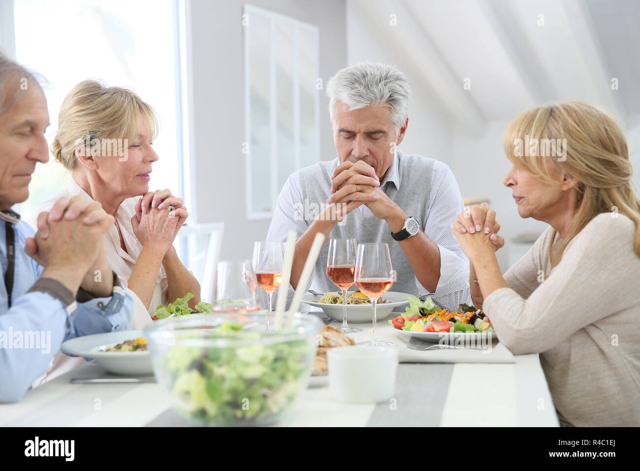 Group of people giving blessings before eating Stock Photo - Alamy
