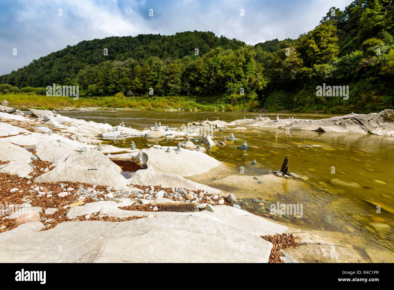 River Buller at Buller Gorge Swing bridge. New Zealand. Pebbles stacked ...