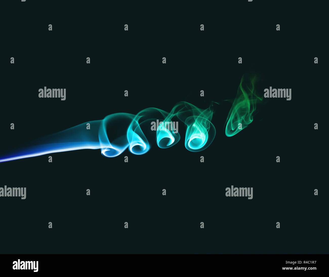 Colored smoke on dark green background Stock Photo - Alamy