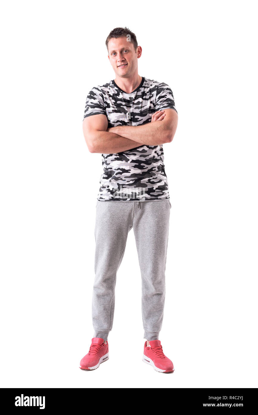 Confident successful muscular sportsman in sweatpants and army shirt ...