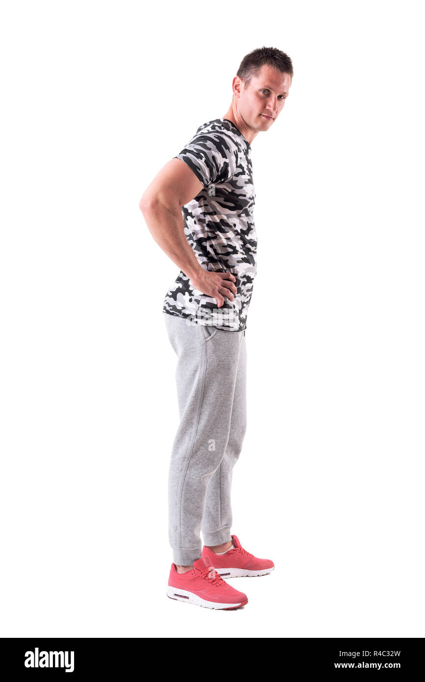 Tough serious young adult macho man with intense look at camera.Full ...