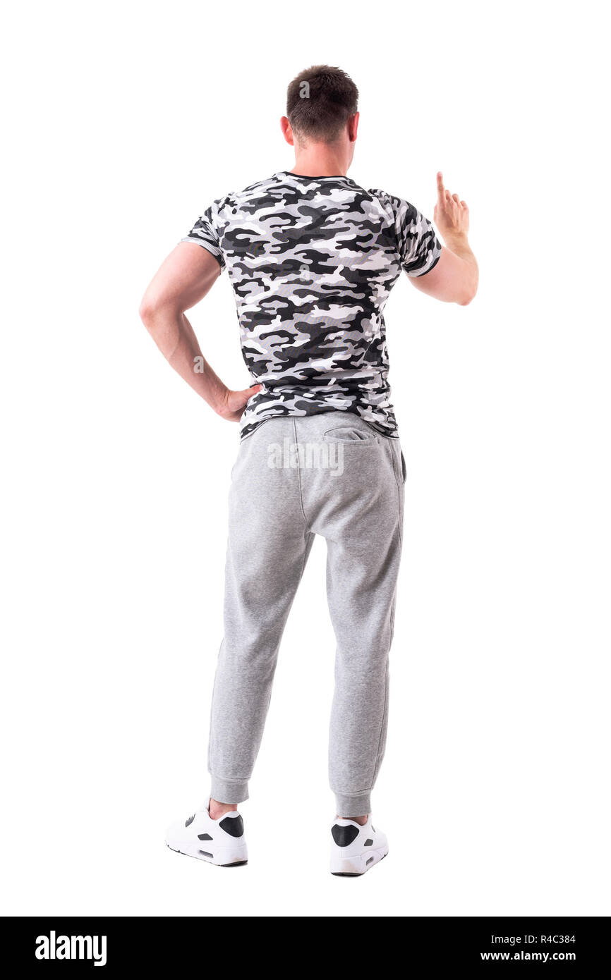 Back view of athletic sporty man pointing finger on interactive screen ...