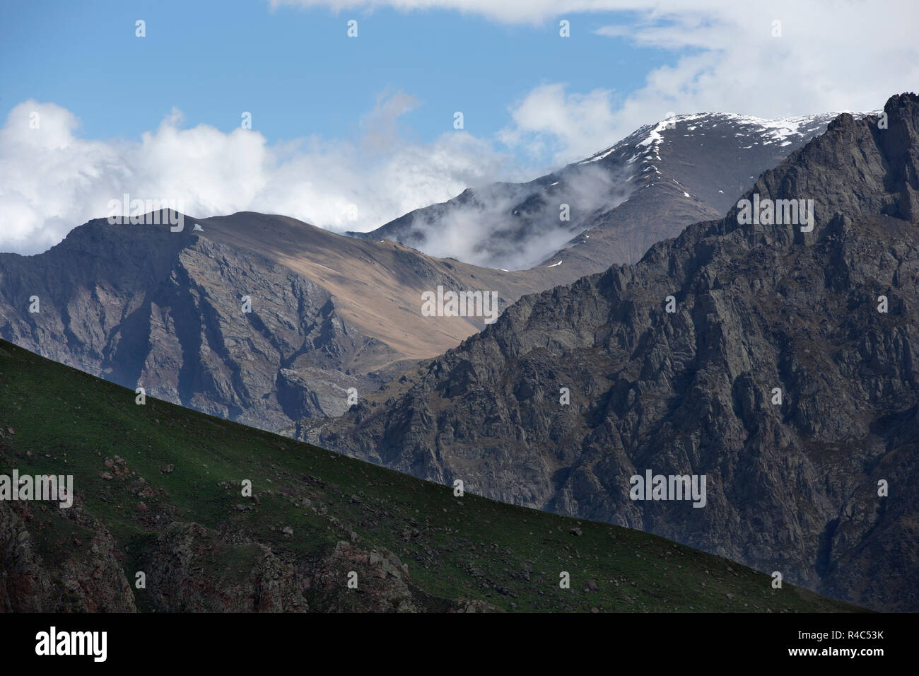 Clouds Flying Between Mountains Stock Photo - Alamy