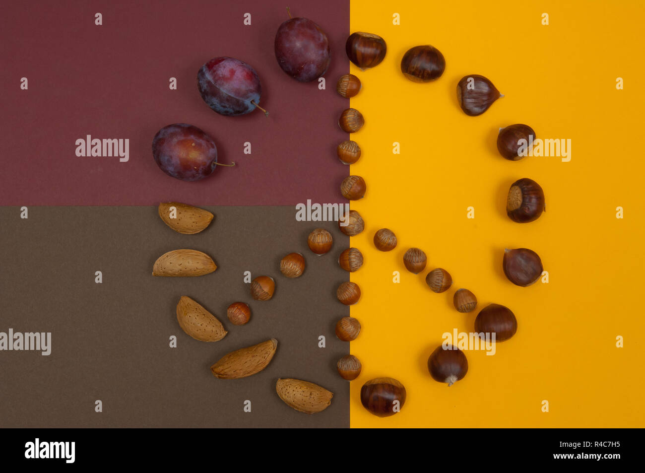 Peace symbol of nuts and autumn fruits on split background Stock Photo ...