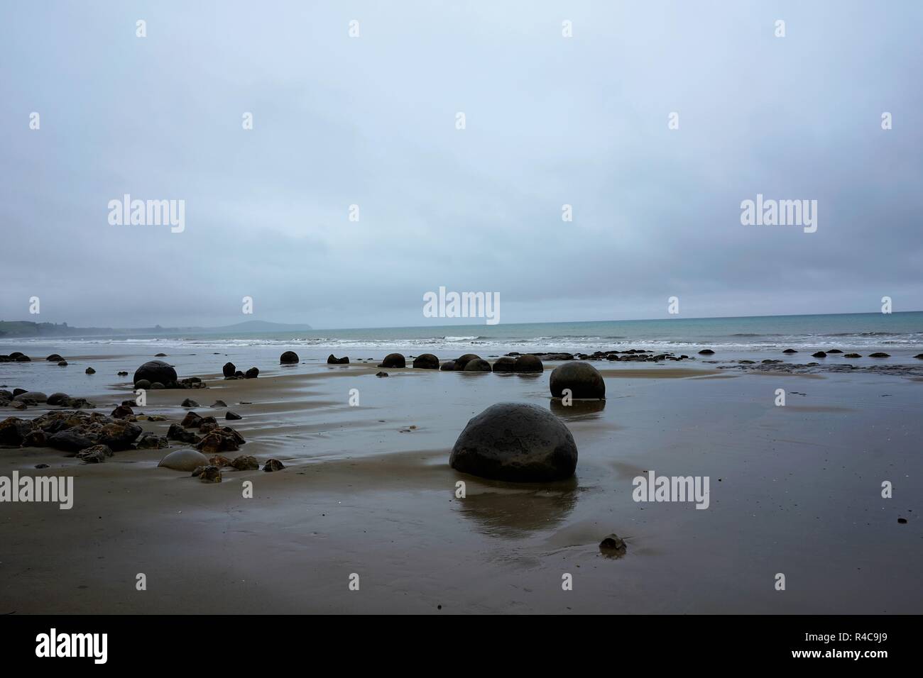 Boulders on the beach in New Zealand Stock Photo - Alamy