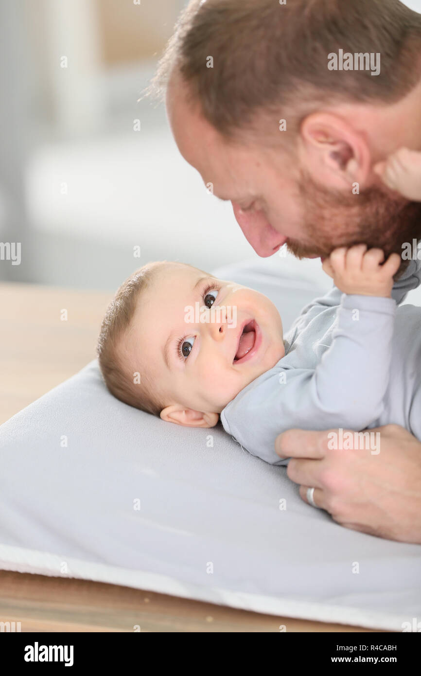 Daddy cuddling baby boy on changing table Stock Photo - Alamy