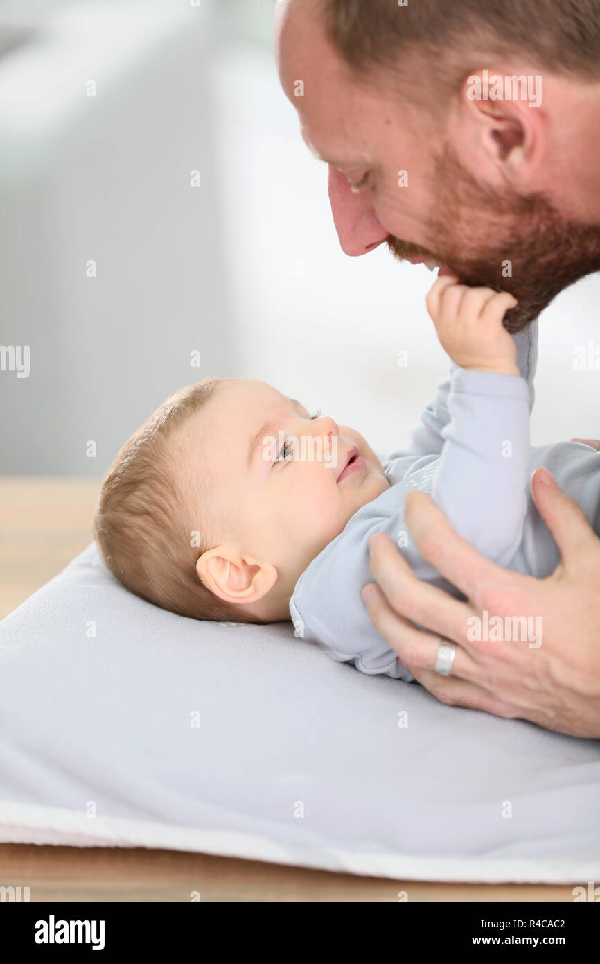 Daddy cuddling baby boy on changing table Stock Photo - Alamy