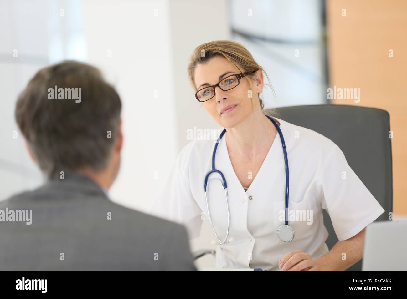 Doctor meeting with patient in hospital office Stock Photo - Alamy