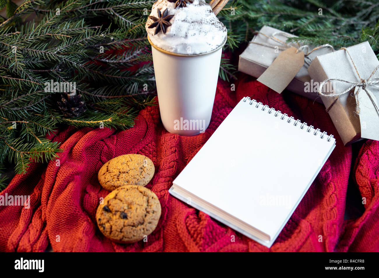 Cup of Coffee with whipped Cream and Cinnamon, oat cookies, blank notepad on christmas tree and ...