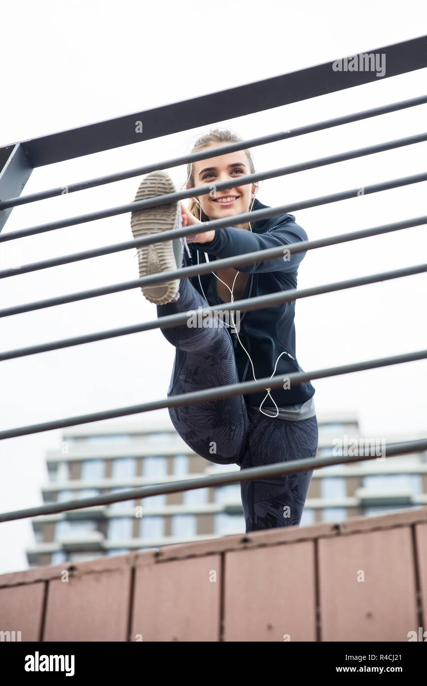 Young woman jumping fence hi-res stock photography and images - Alamy