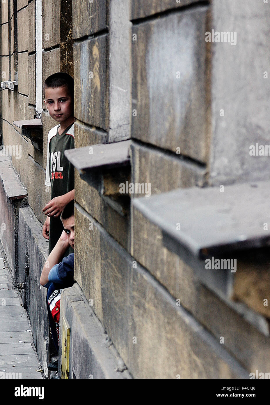 polish street kids in doorway looking at camera lens in Krakow’s Ghetto ...