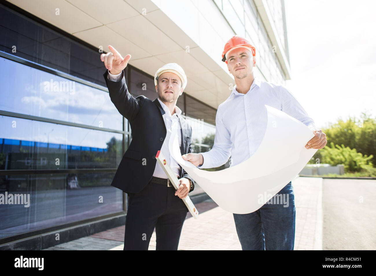 View of an Engineer and worker checking plan on construction site Stock ...