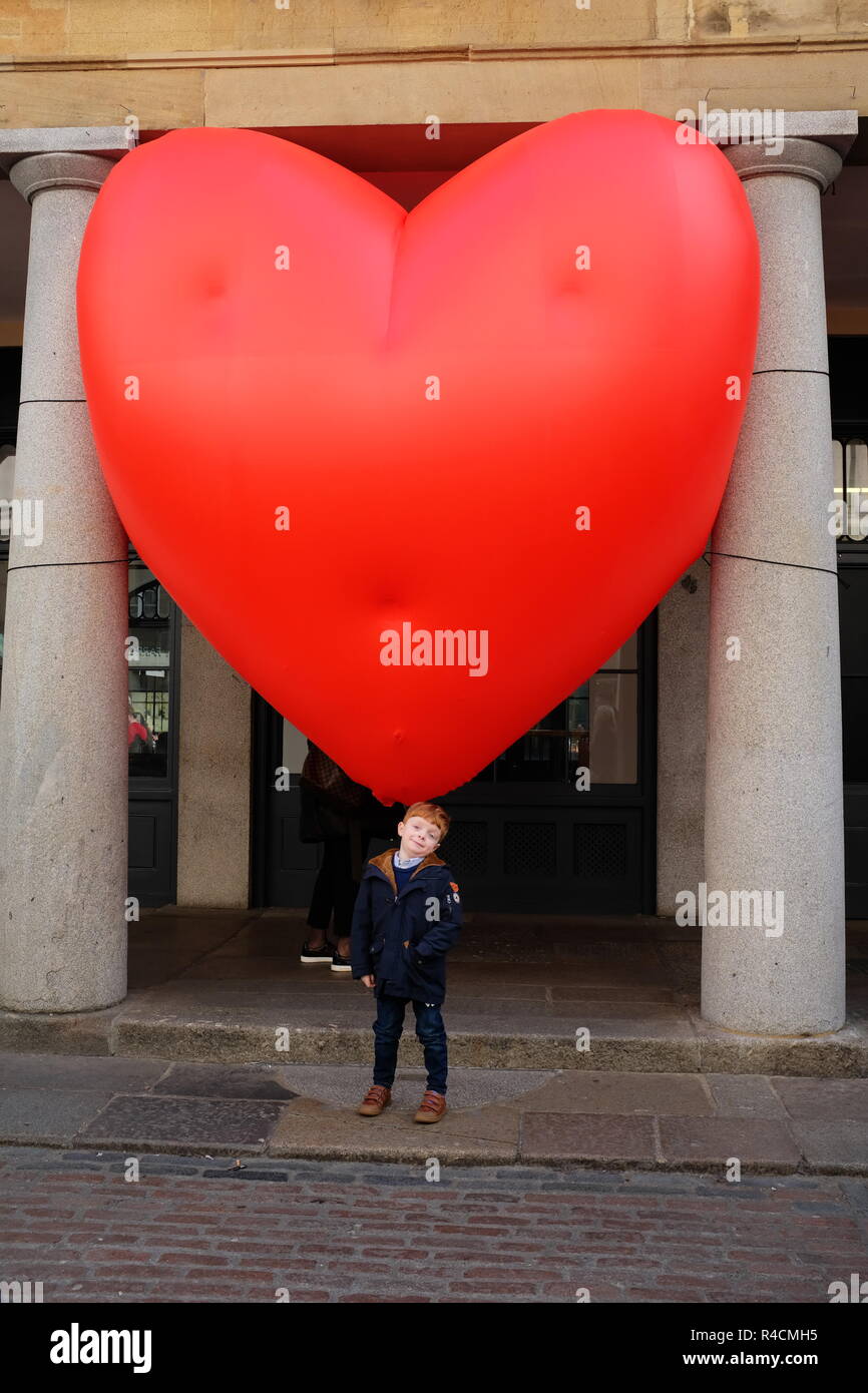 Little boy under Giant inflatable love heart, Covent Garden, London ...