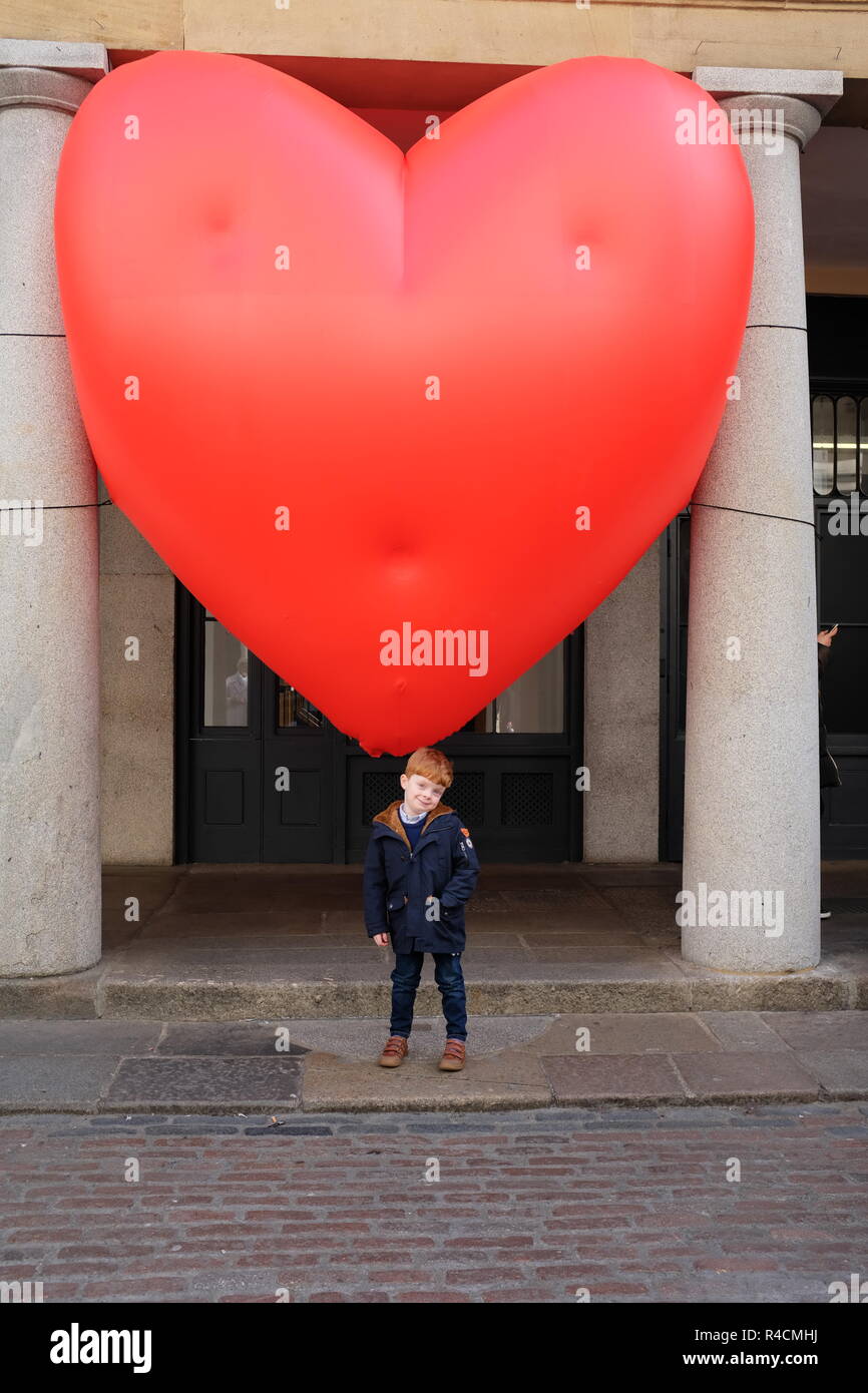Little boy under Giant inflatable love heart, Covent Garden, London ...