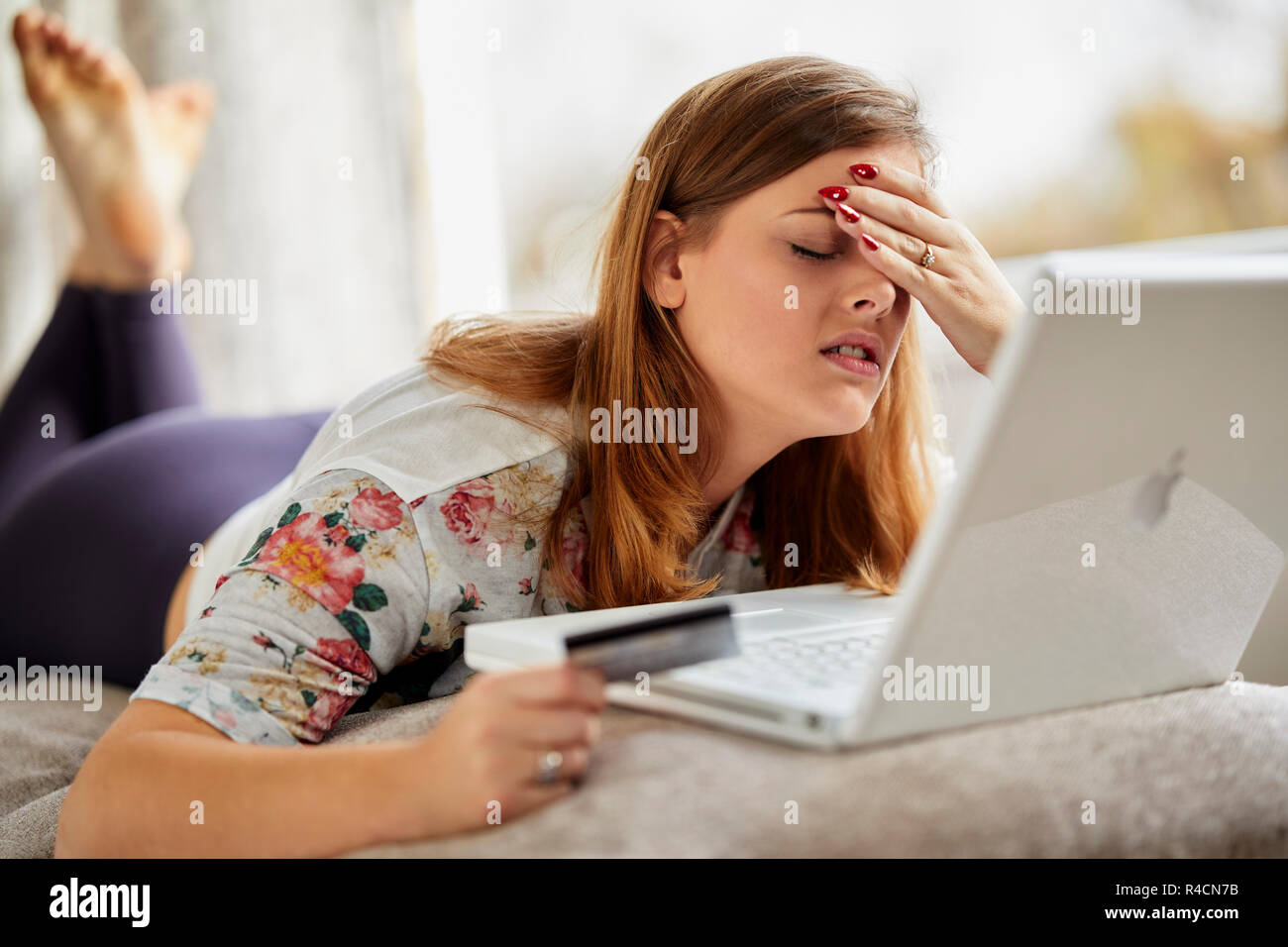 Girl overspent using her credit card Stock Photo - Alamy