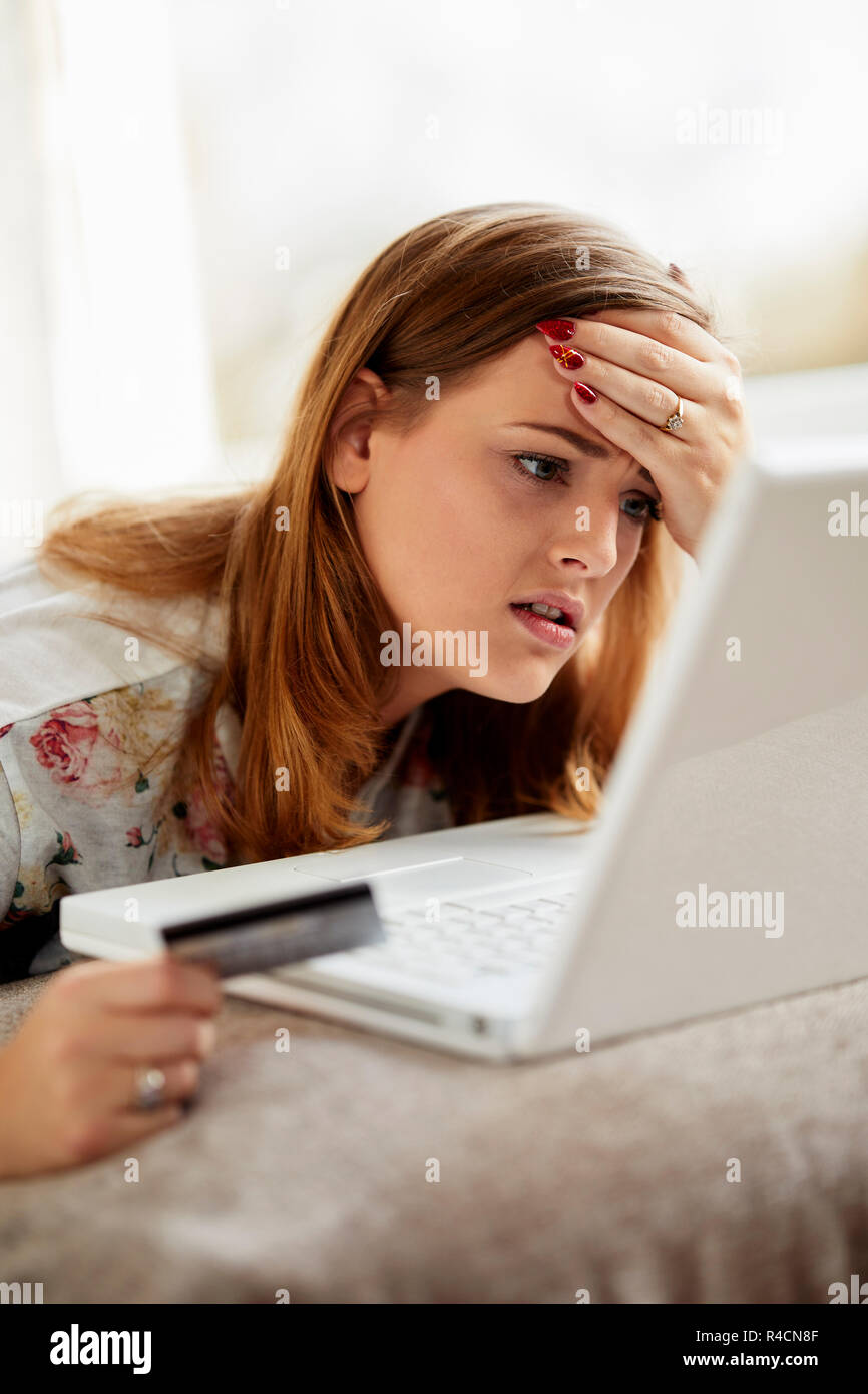 Girl overspent using her credit card Stock Photo - Alamy