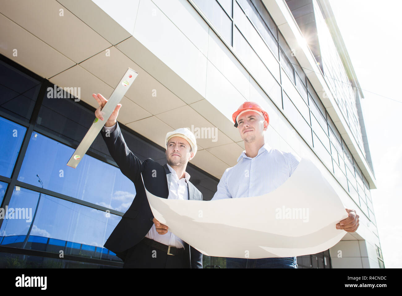 View of an Engineer and worker checking plan on construction site Stock ...