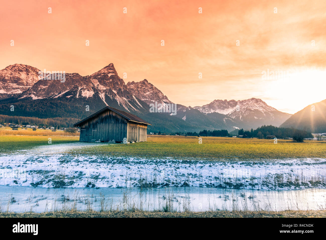 Wooden barn and alpine snowy scenery Stock Photo - Alamy