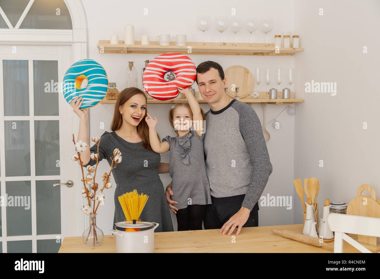 Fun and beautiful family of three having fun in the kitchen Stock Photo ...
