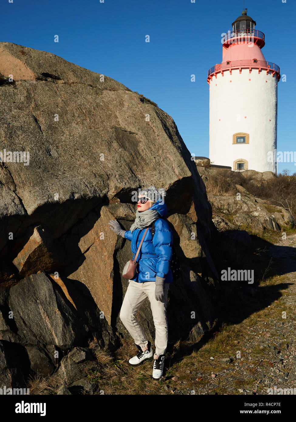 Beautiful woman posing near lighthouse. Travel the world concept Stock ...
