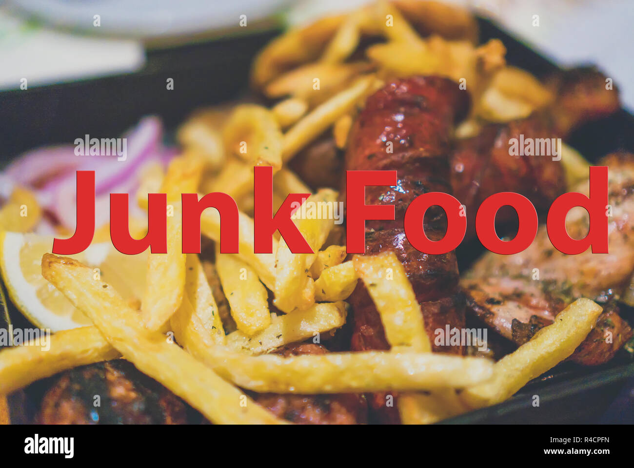 Junk food concept. French fries with sausages Stock Photo - Alamy