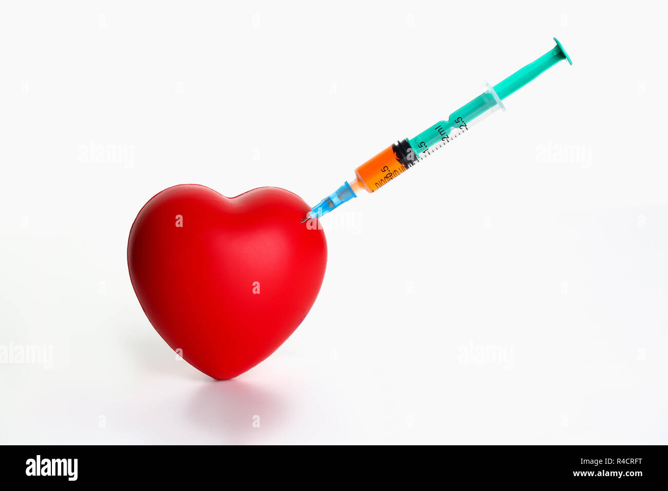 Red heart with stuck syringe on gray background Stock Photo - Alamy