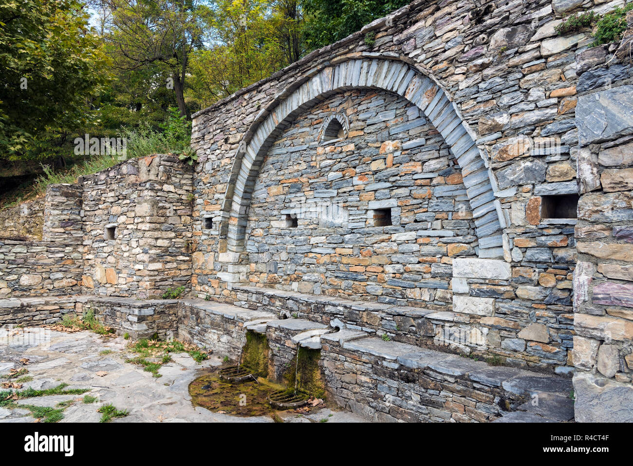 Traditional stone drinking fountain in the village of Kokkinopilos on ...