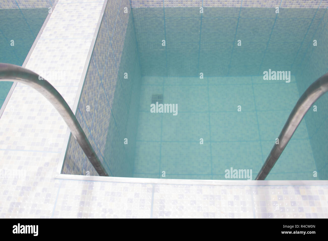 The pool is small in the building. Descent to the pool. Square pool ...