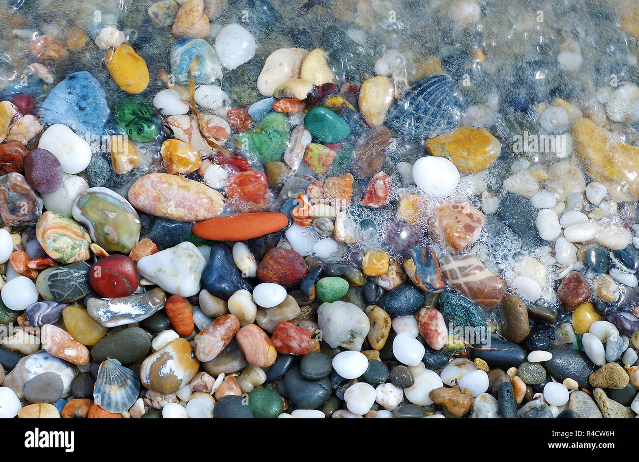 Colorful pebbles in the sea wave Stock Photo - Alamy