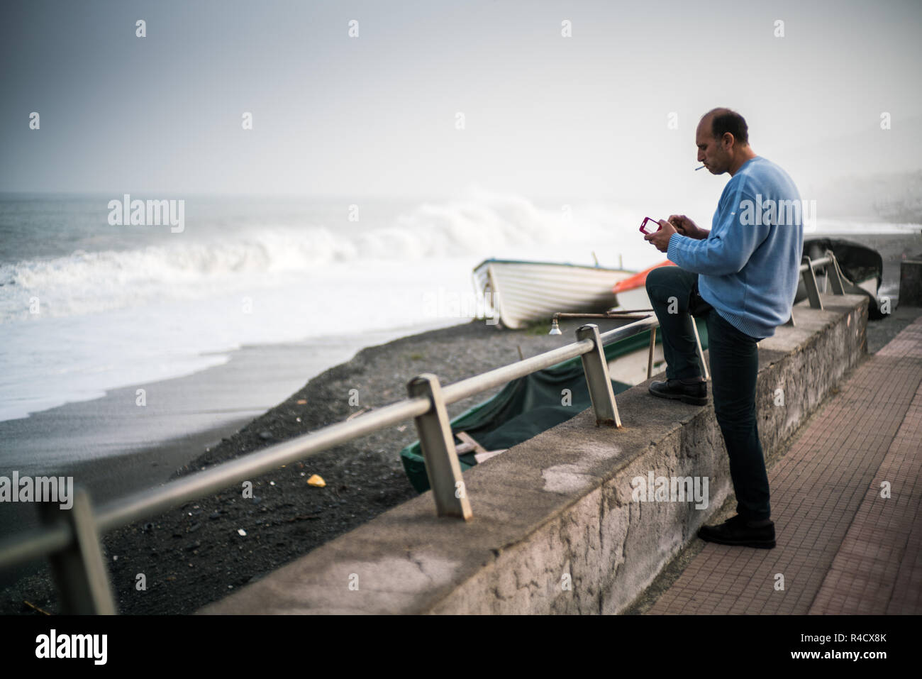 Man with phone on the beach, Sicily, Italy, Europe Stock Photo - Alamy