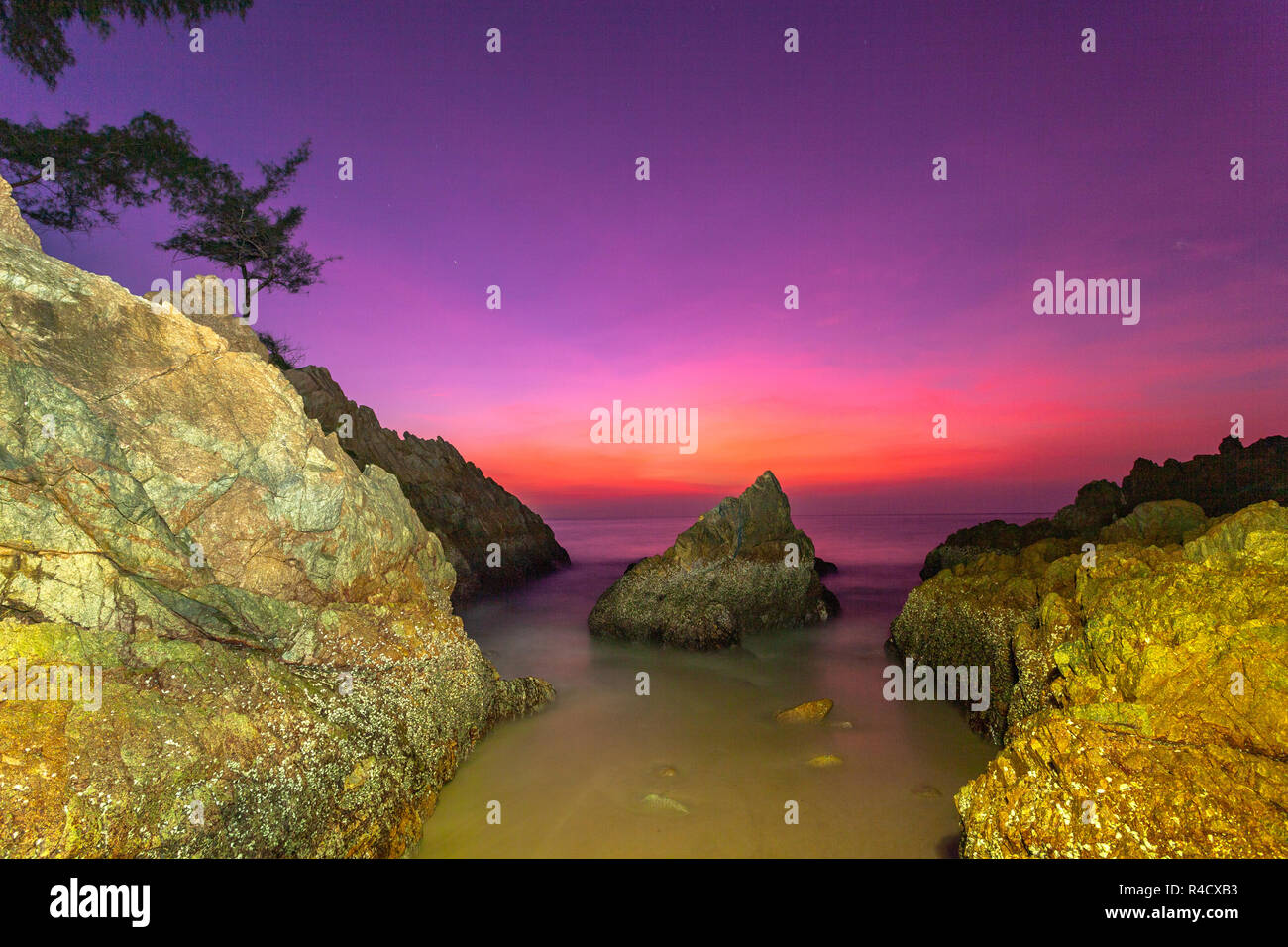 waves hit the big cone shape rock in the middle of stone cape during ...