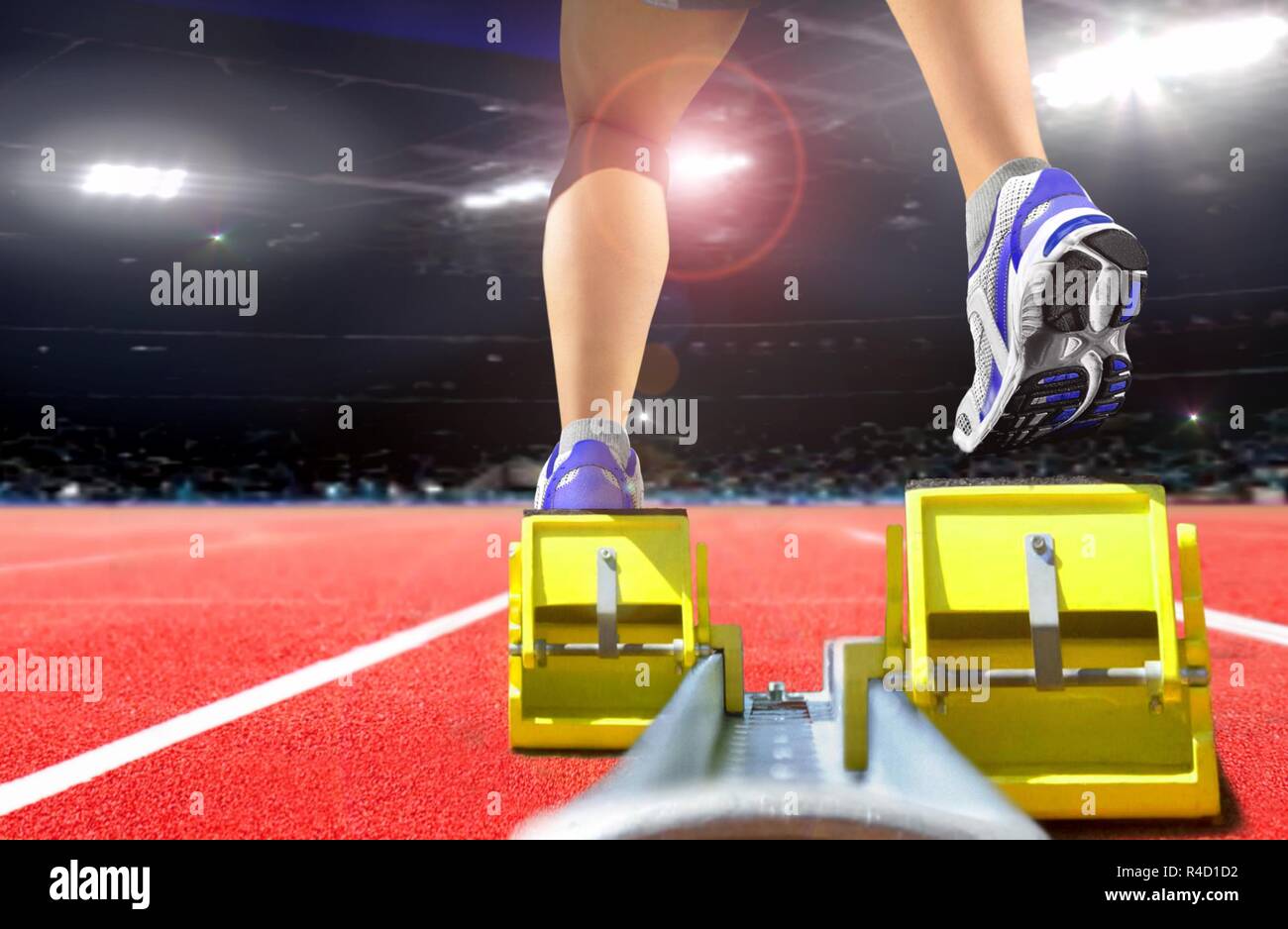 Legs of athlete on running block in the stadium Stock Photo - Alamy