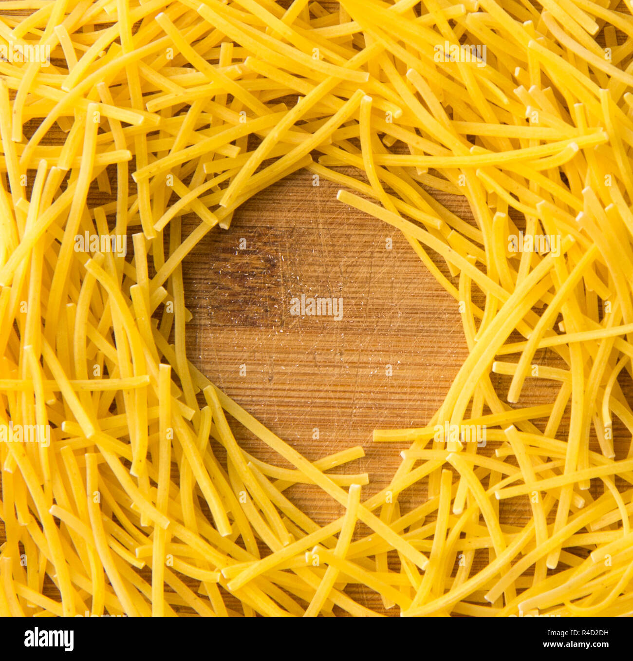 small dry frame pasta noodles on wood background Stock Photo - Alamy