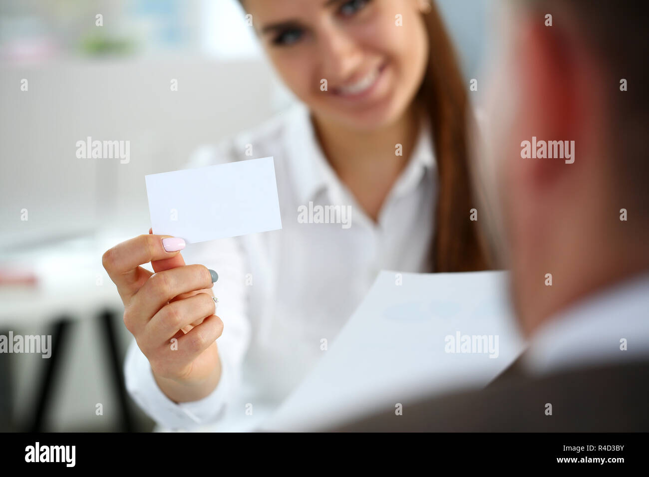 Female arm in suit give blank calling card to visitor Stock Photo - Alamy