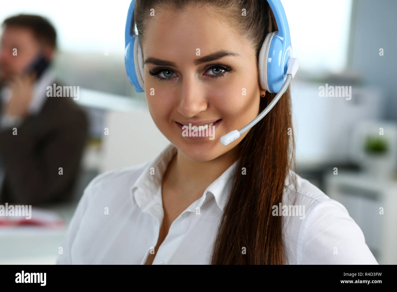 Beautiful brunette smiling call centre clerk at work Stock Photo - Alamy