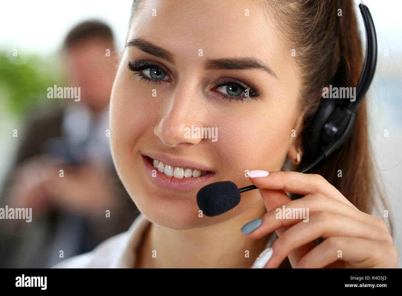 Beautiful brunette smiling call centre clerk at work Stock Photo - Alamy