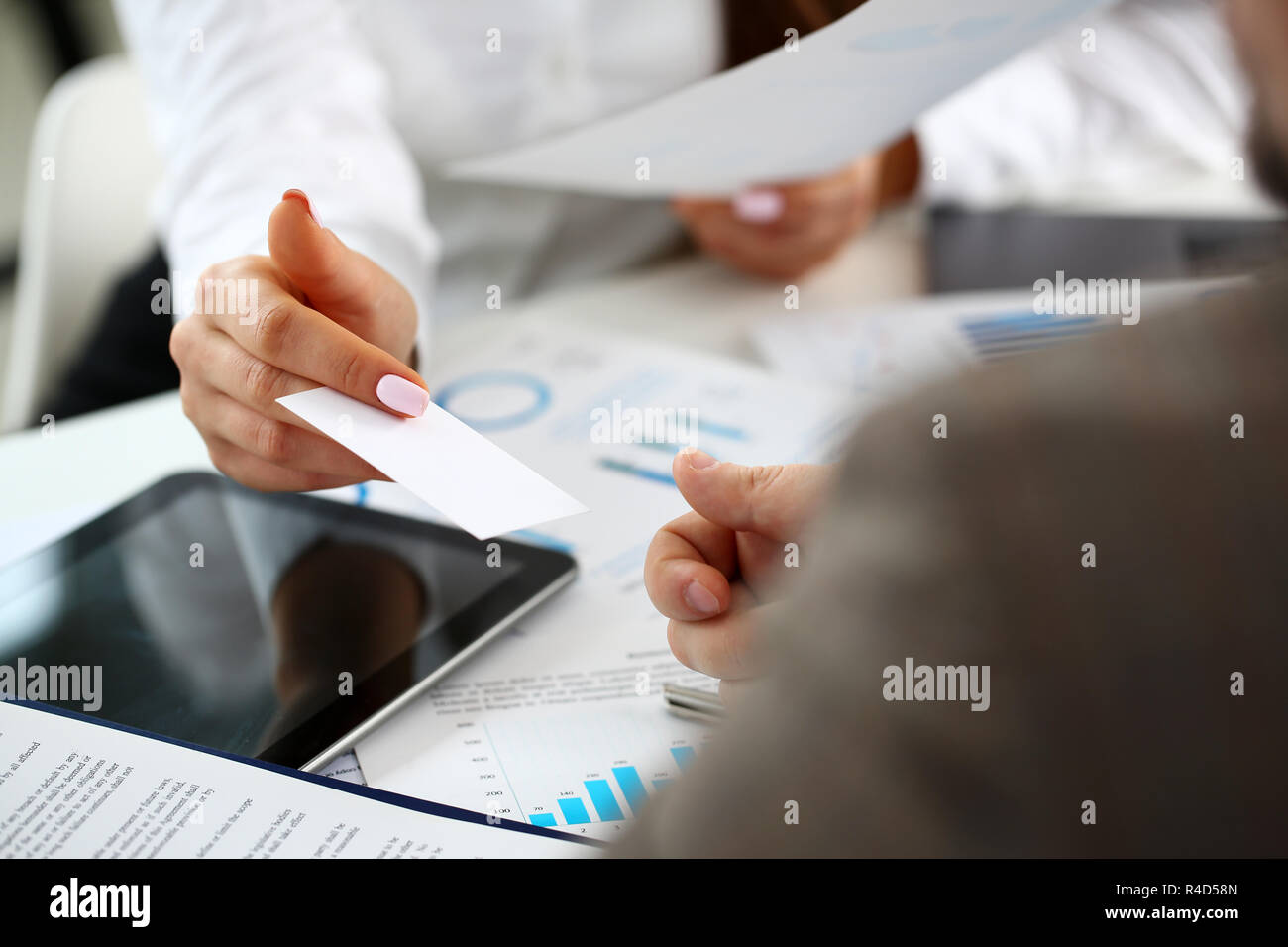 Female arm in suit give blank calling card to visitor Stock Photo - Alamy
