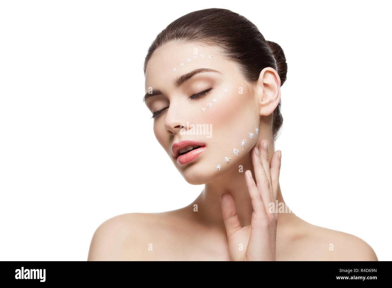 Girl with cream dots on face Stock Photo - Alamy