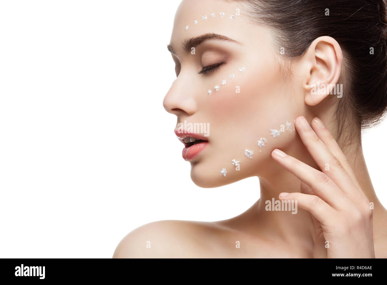 Girl with cream dots on face Stock Photo - Alamy