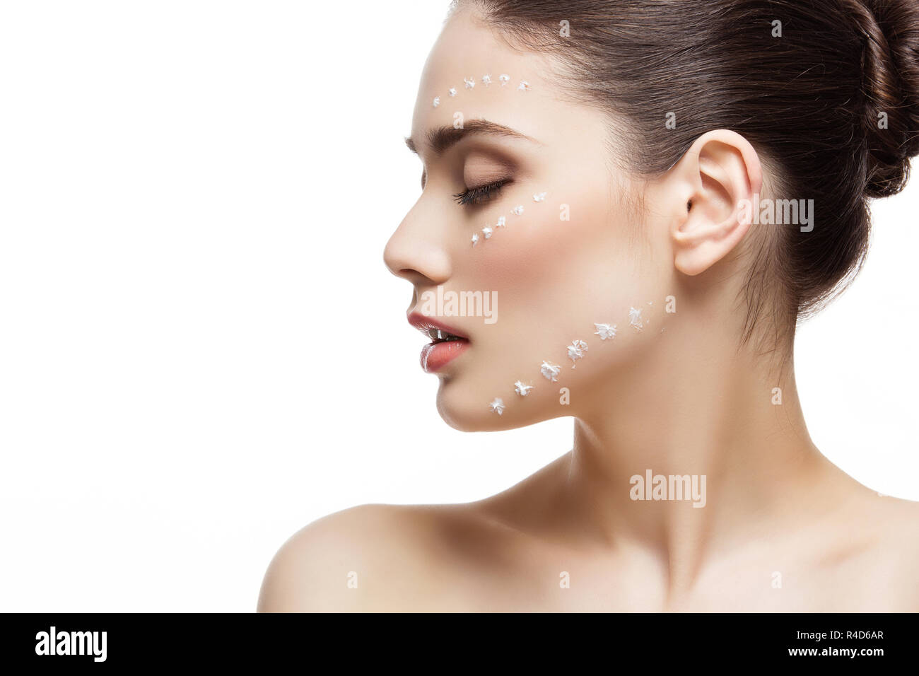 Girl with cream dots on face Stock Photo - Alamy