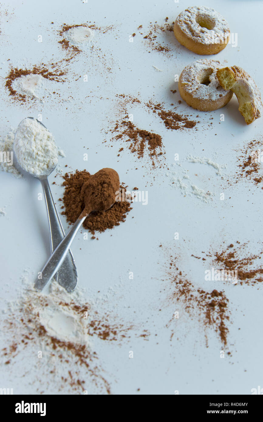 Pastry background (two spoons with cocoa, flour and cookies) with space ...