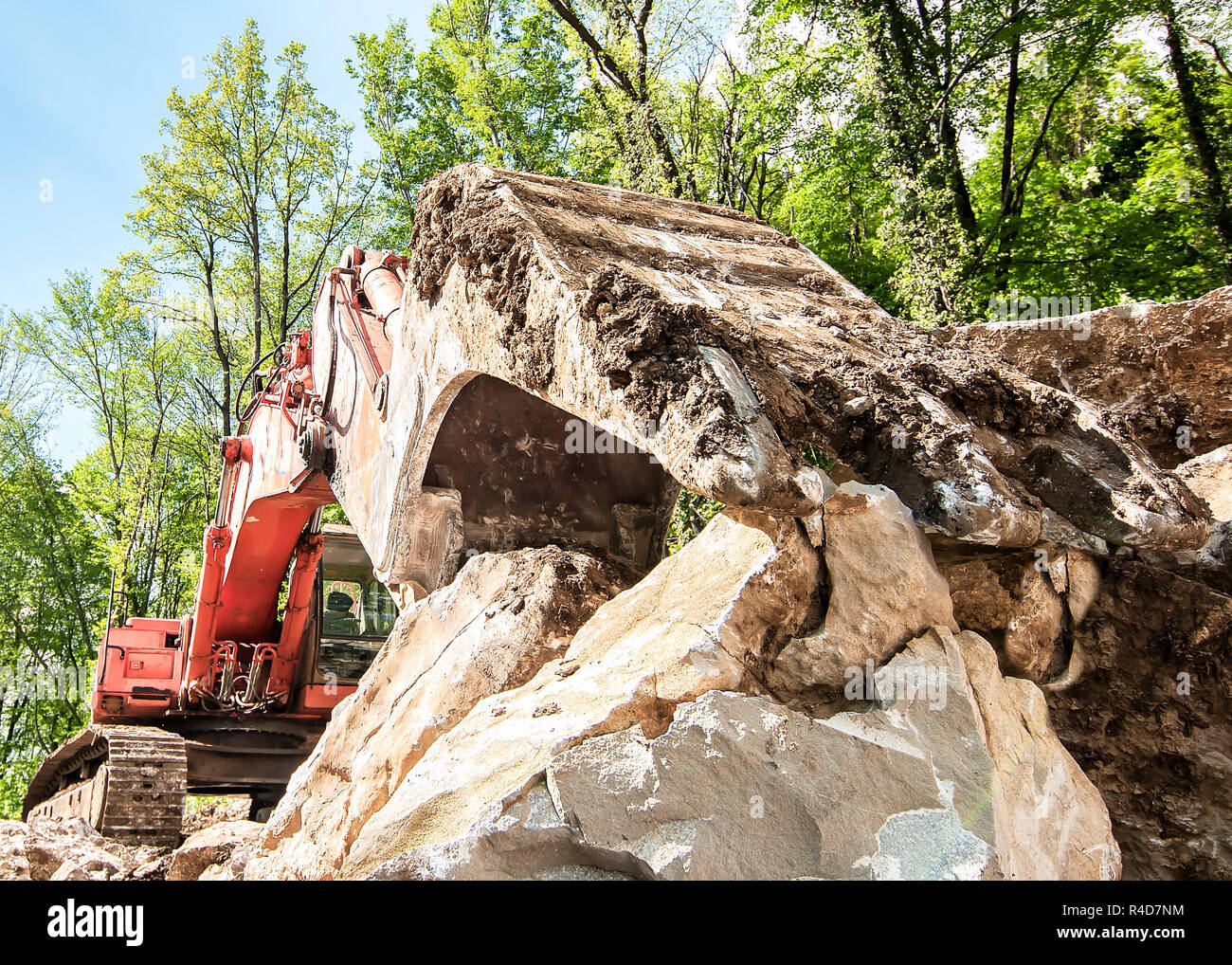 Excavator with big shovel to work with rocks Stock Photo - Alamy