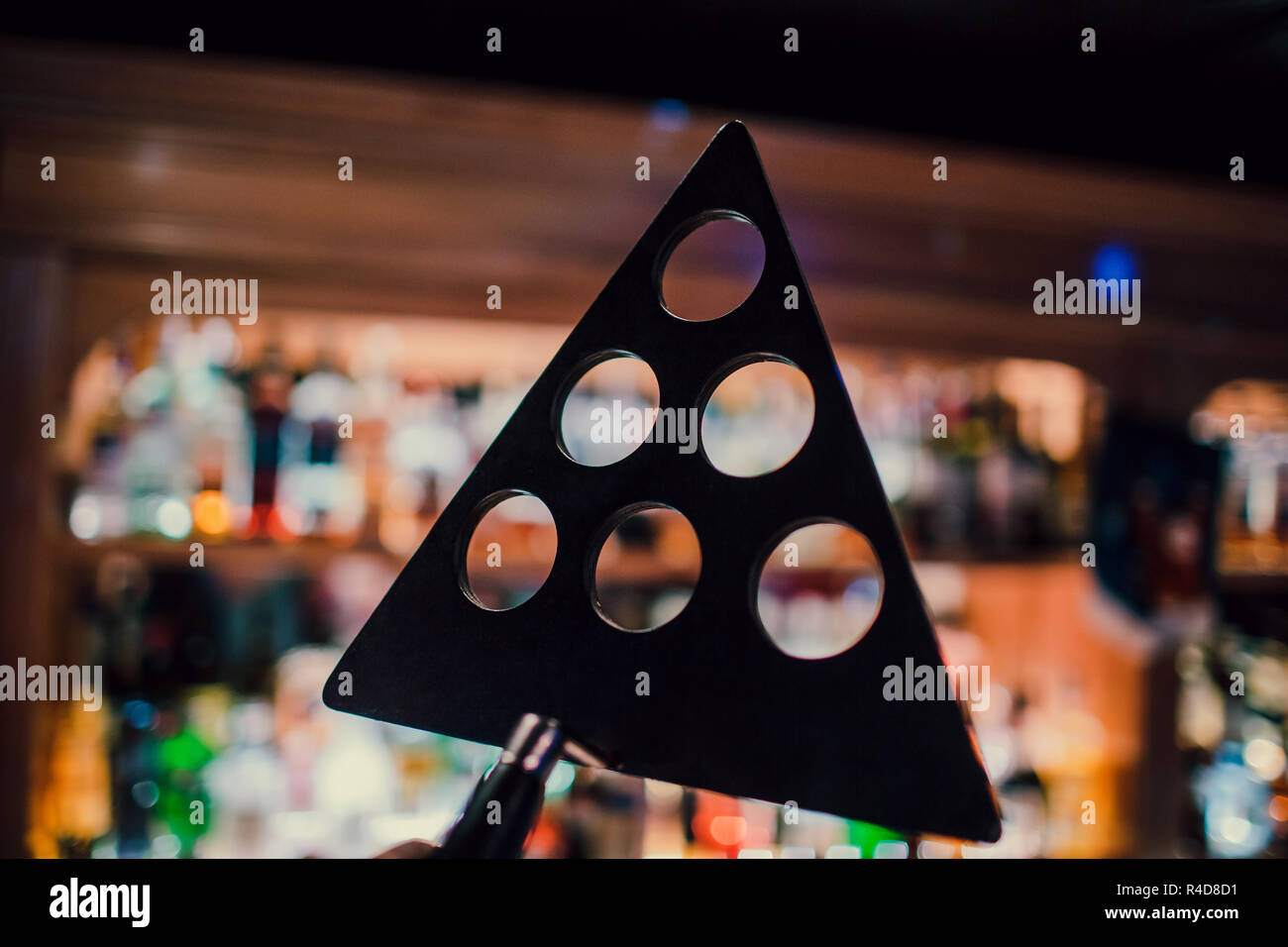 stand for alcoholic shots, a triangle of wood, the concept of serving ...
